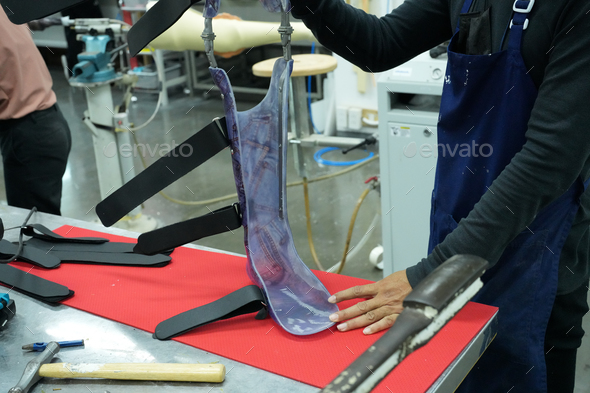 Orthopedic technician making prosthetic leg for disabilities people in workshop. Stock Photo by ...